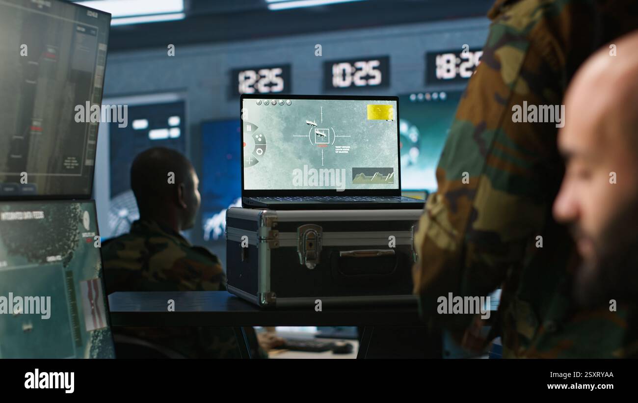 Air force combat control agent performing tactical level surveillance in war room using laptop ...