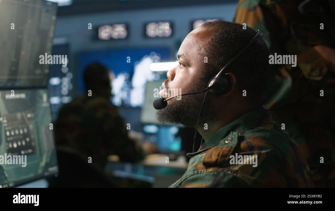 Army telecommunication systems operator using radio and satellite gear ...