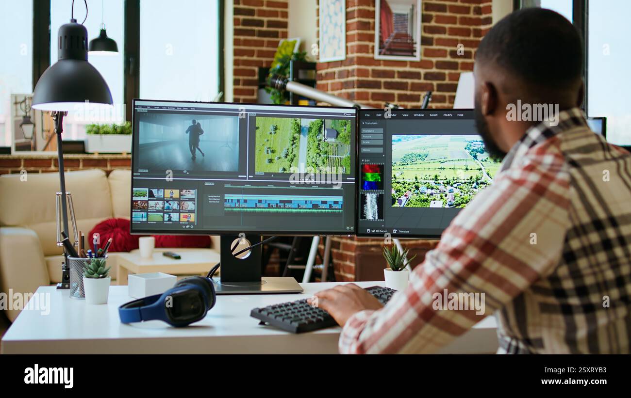 African american man video editor working in video production industry, does color grading and ...