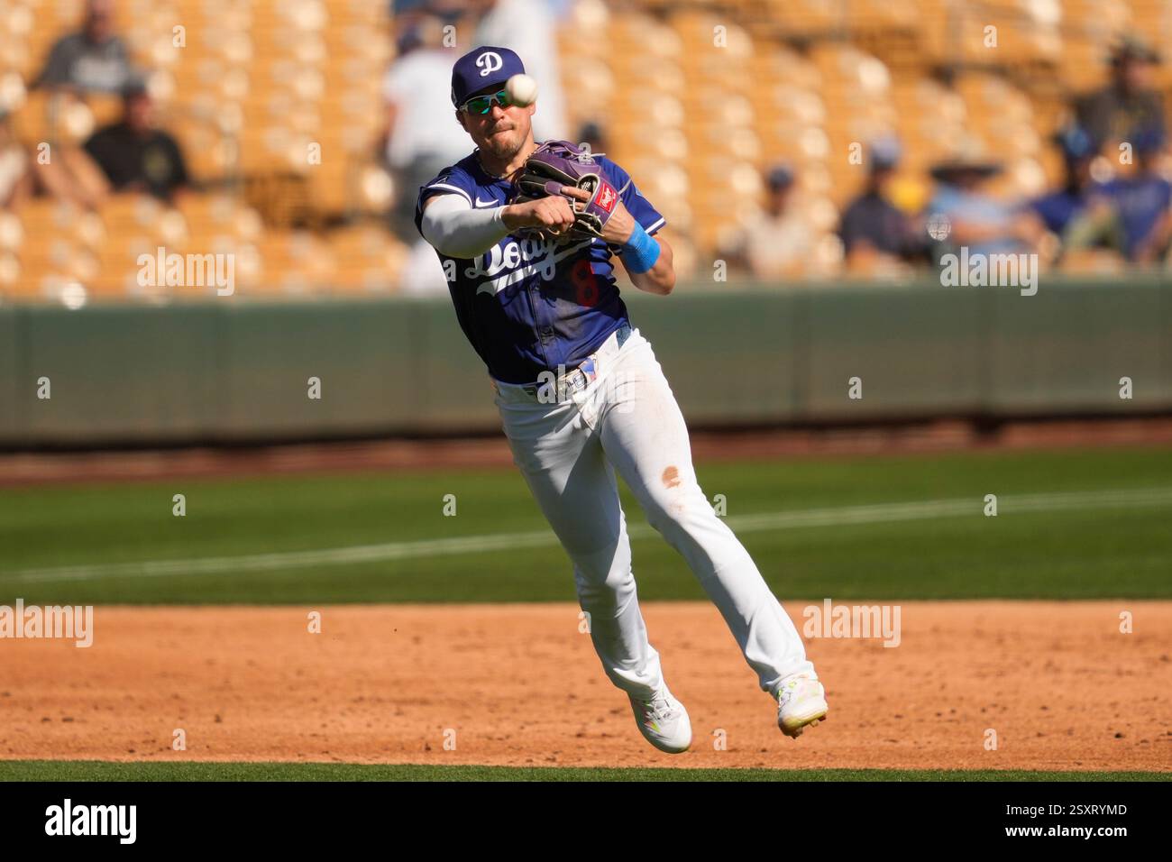 Los Angeles Dodgers third baseman Enrique Hernandez throws to first to ...