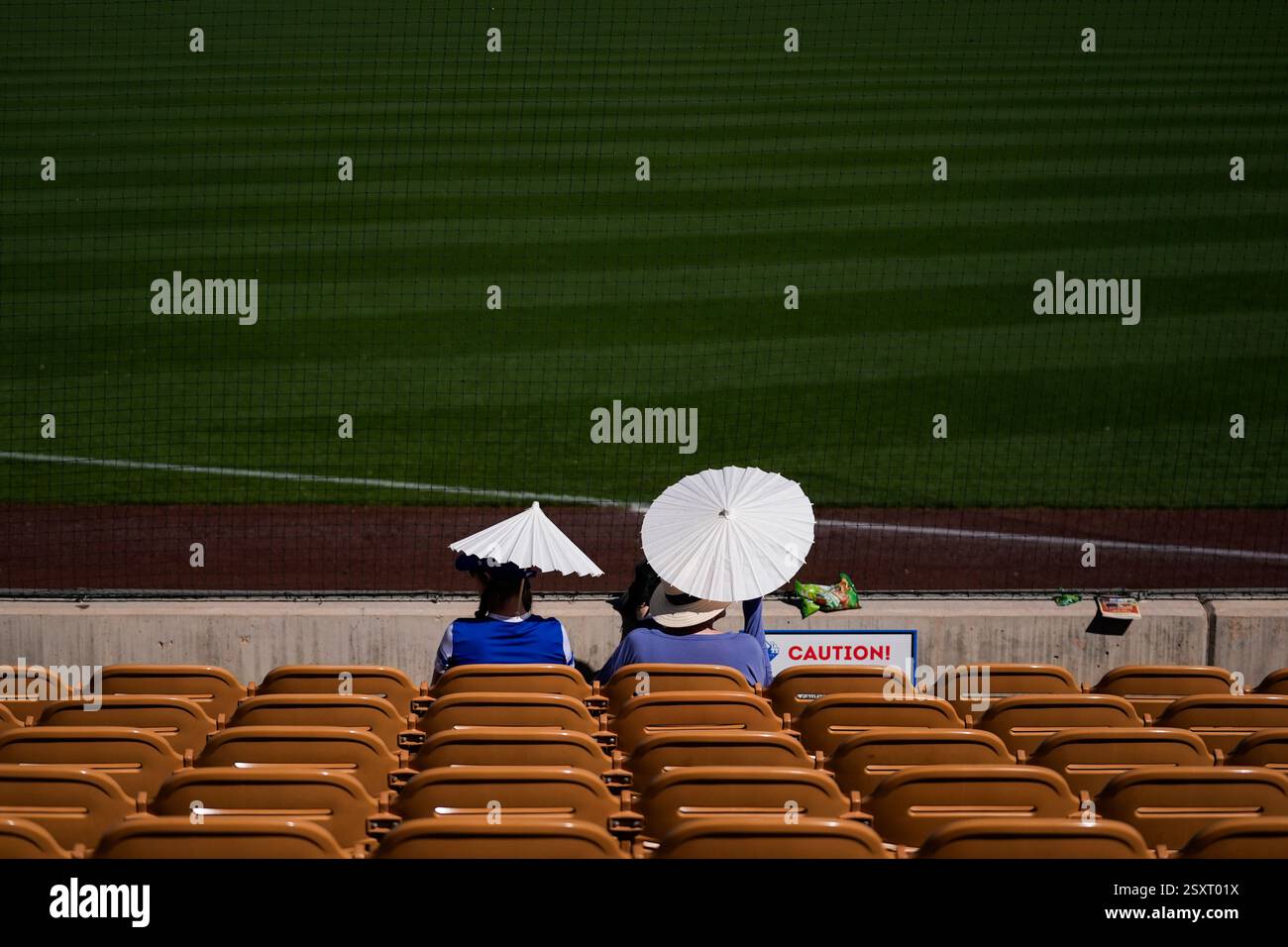 Fans watch a spring training baseball game between the Seattle Mariners ...
