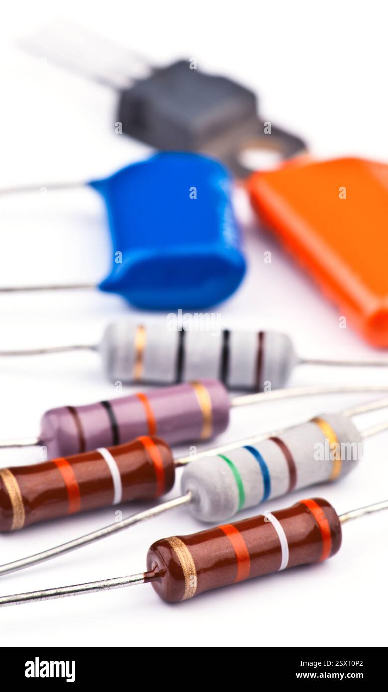 A collection of resistors and capacitors arranged neatly on a white background. The components ...