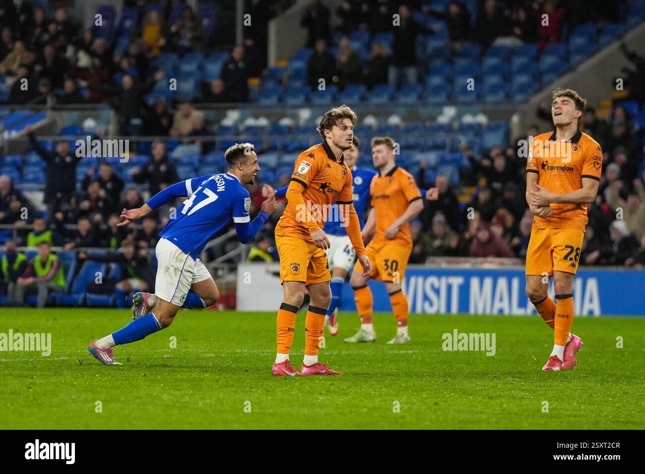 Cardiff, UK. 25th Feb, 2025. Callum Robinson of Cardiff City scores his teams first goal to make ...