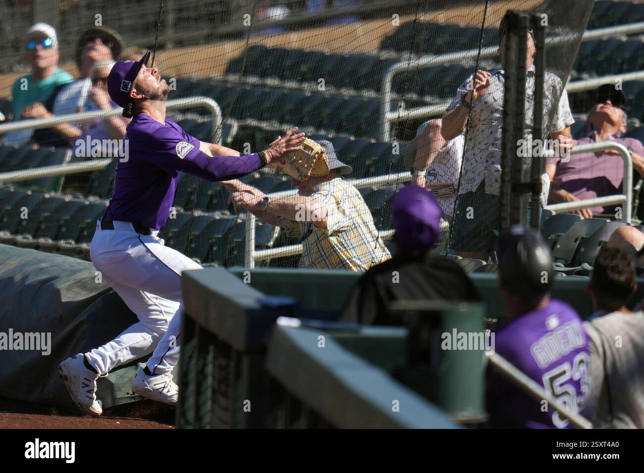 Colorado Rockies first baseman Kyle Farmer hits the stadium netting in ...