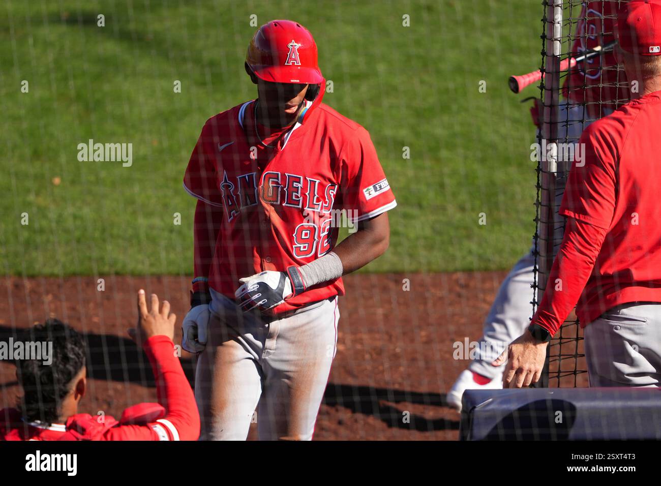 Los Angeles Angels' Denzer Guzman is greeted by teammates after scoring ...