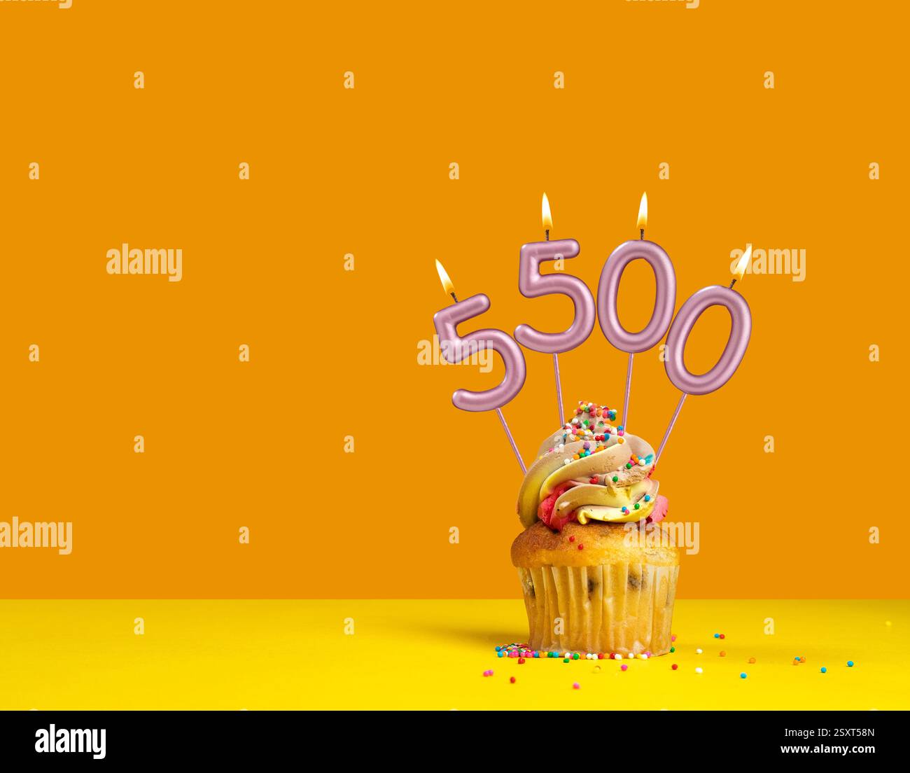 Candles forming the number 5500 - Yellow background Stock Photo - Alamy