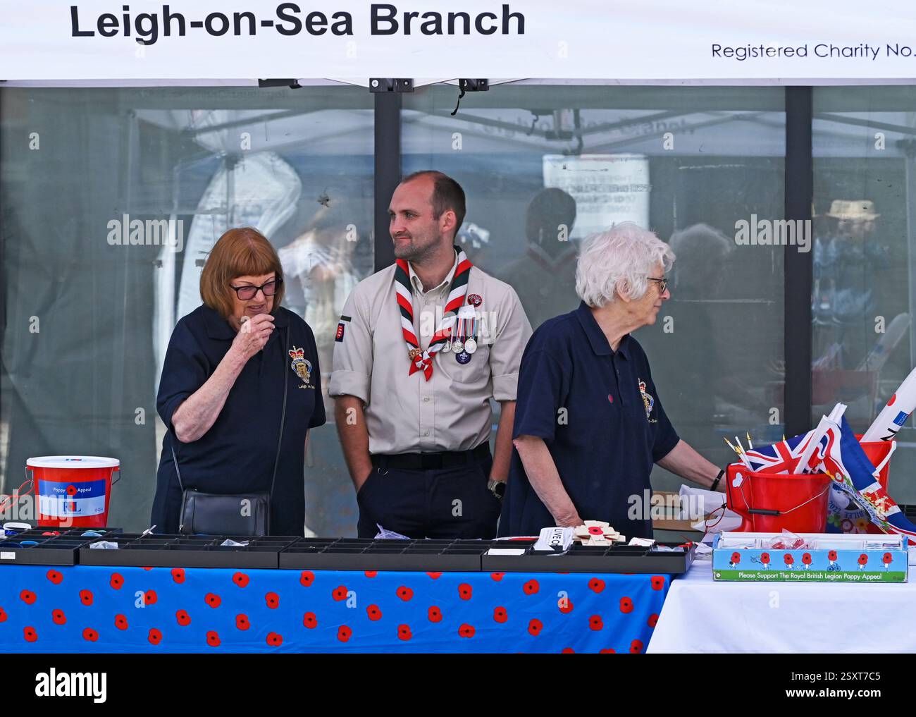 A scout leader wearing medals and two women at the the Royal British ...