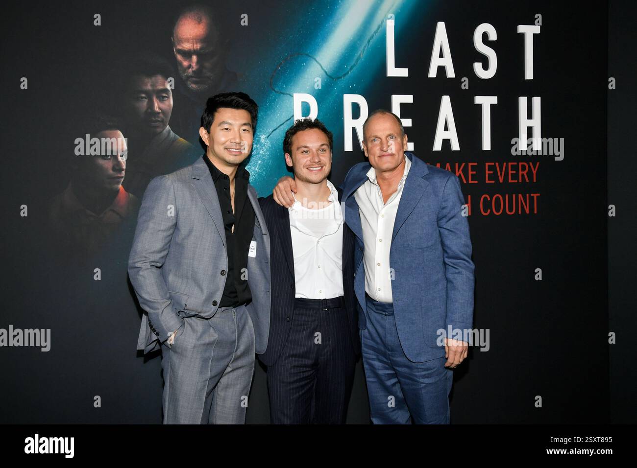 Simu Liu, from left, Finn Cole, and Woody Harrelson attend the premiere ...