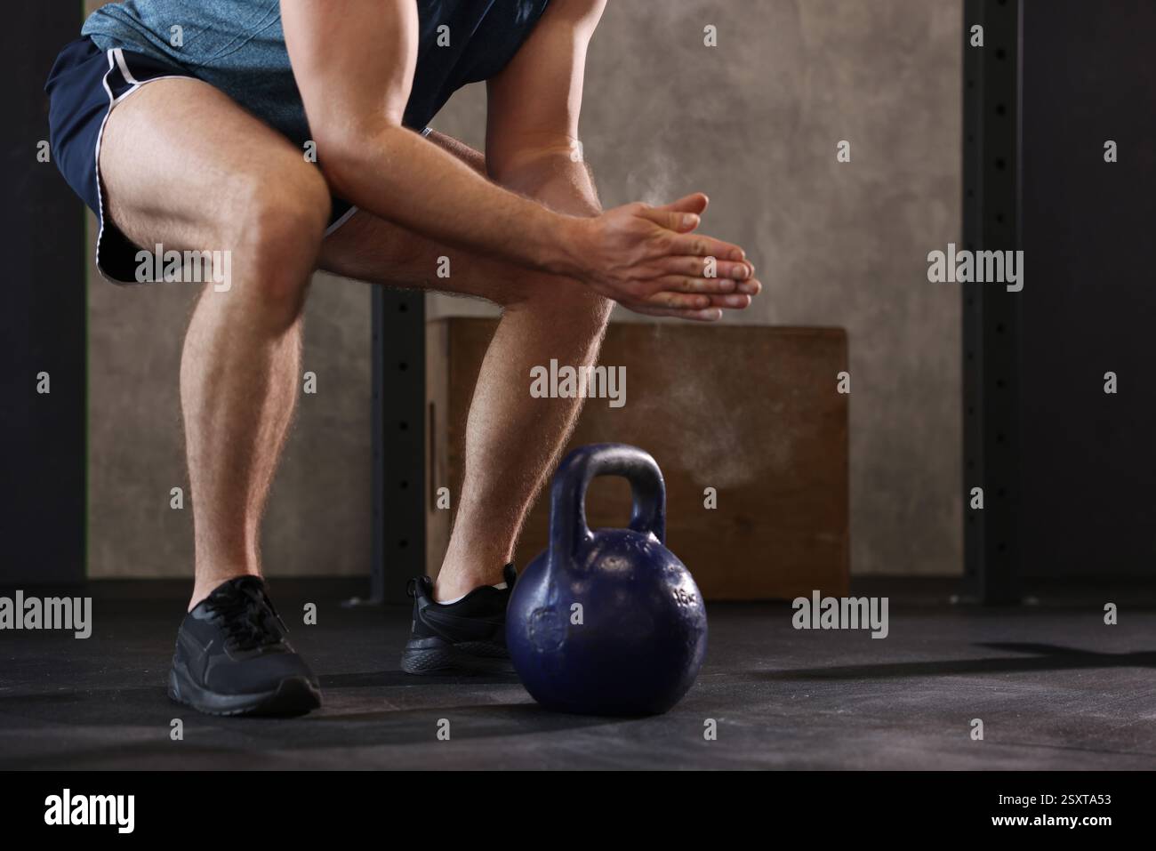 Sportsman clapping hands with talcum powder before crossfit workout ...