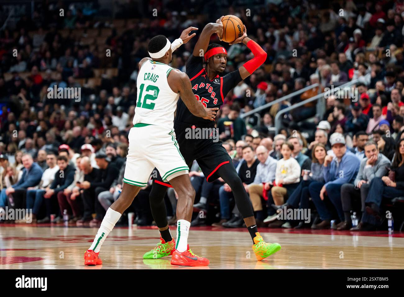 Toronto Raptors forward Chris Boucher (25) plays the ball against Boston Celtics forward Torrey ...