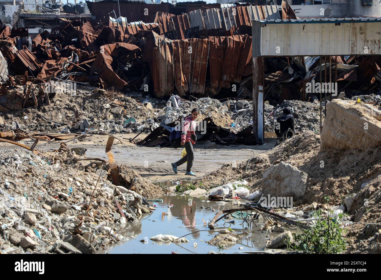 Gaza. 25th Feb, 2025. A Palestinian child walks in one of the ...
