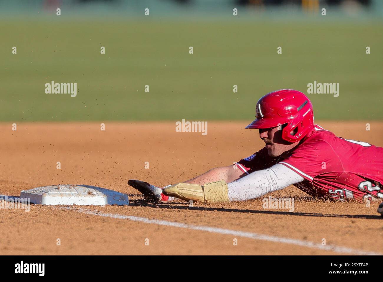 February 25, 2025: Logan Maxwell (22) of Arkansas slides first face ...