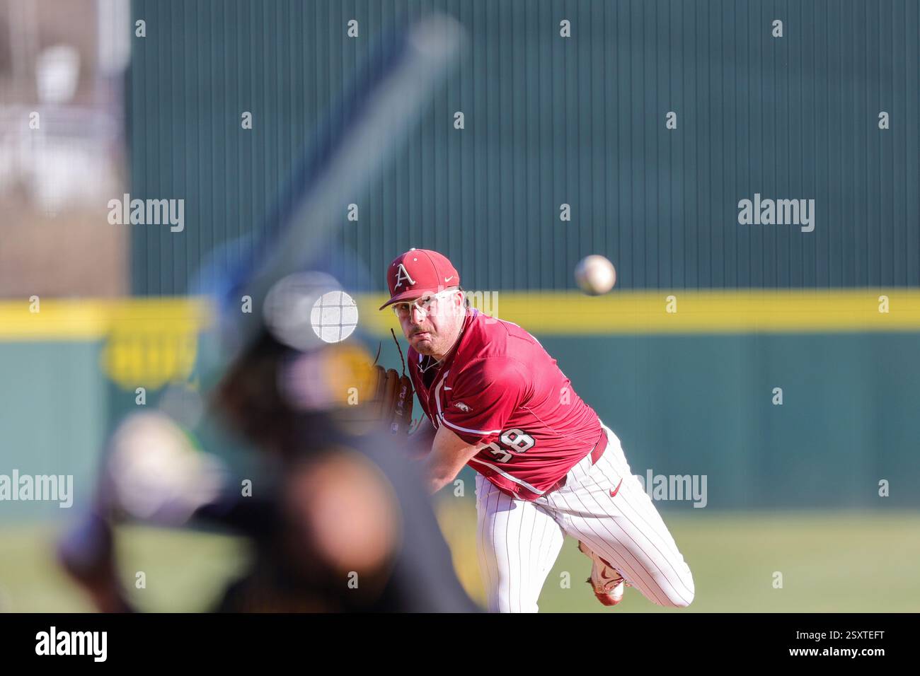 February 25, 2025: Razorback pitcher Colin Fisher (38) eyes a ball as ...