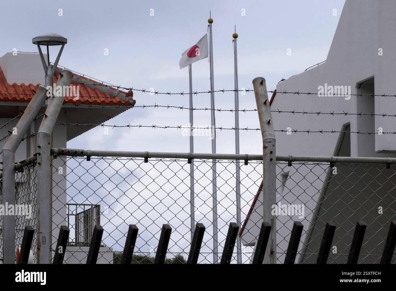 A Japanese flag flutters in the wind inside the Japan Self-Defense ...