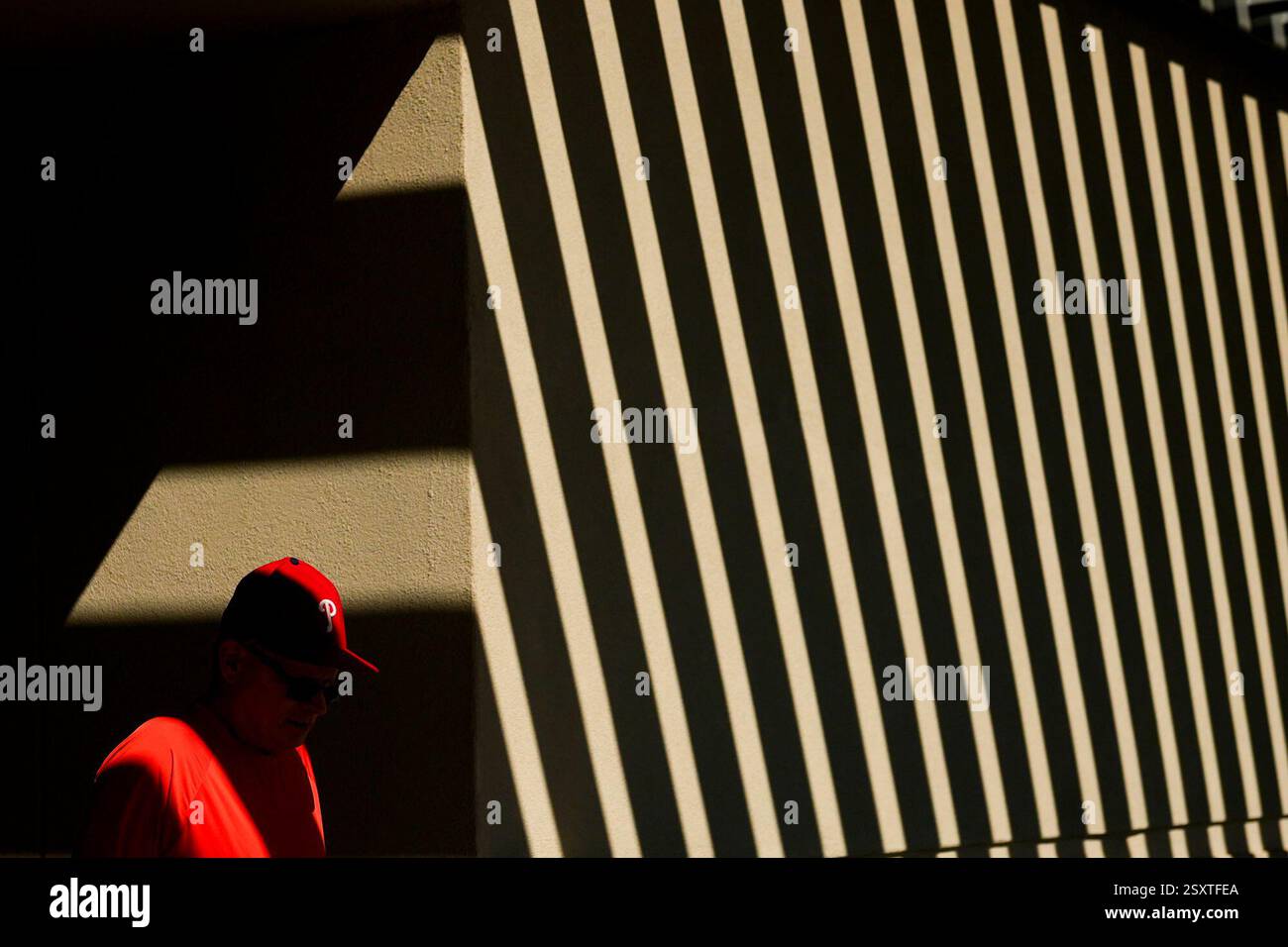 A fan walks through shadows in the upper concourse before a spring ...