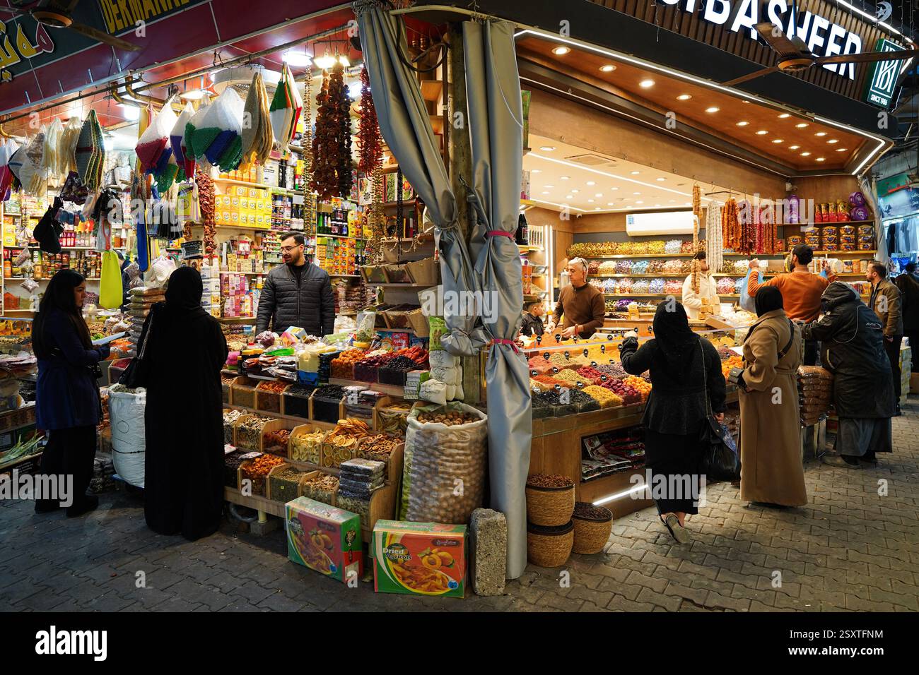 Women shop at a spice shops in the city of Duhok in the Kurdistan ...
