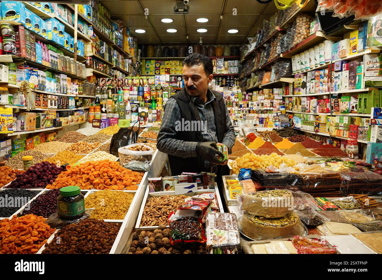 Duhok, Iraq. 25th Feb, 2025. An Iraqi Kurdish vendor sells spices in ...