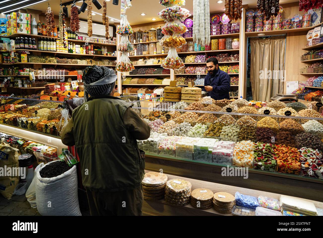 Duhok, Iraq. 25th Feb, 2025. An Iraqi Kurdish vendor sells spices in ...