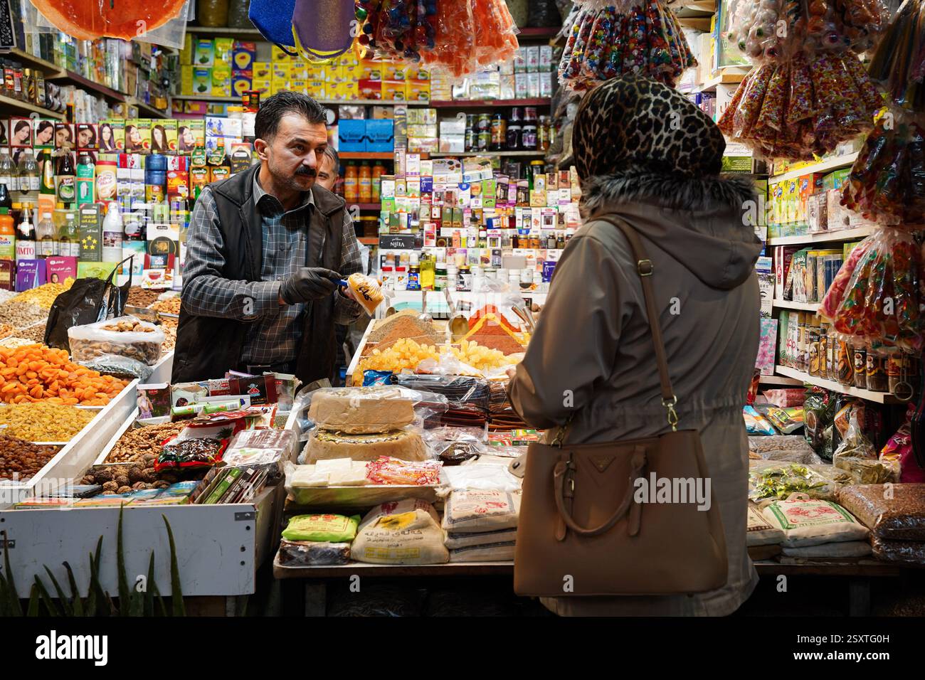 Duhok, Iraq. 25th Feb, 2025. An Iraqi Kurdish vendor sells spices in ...