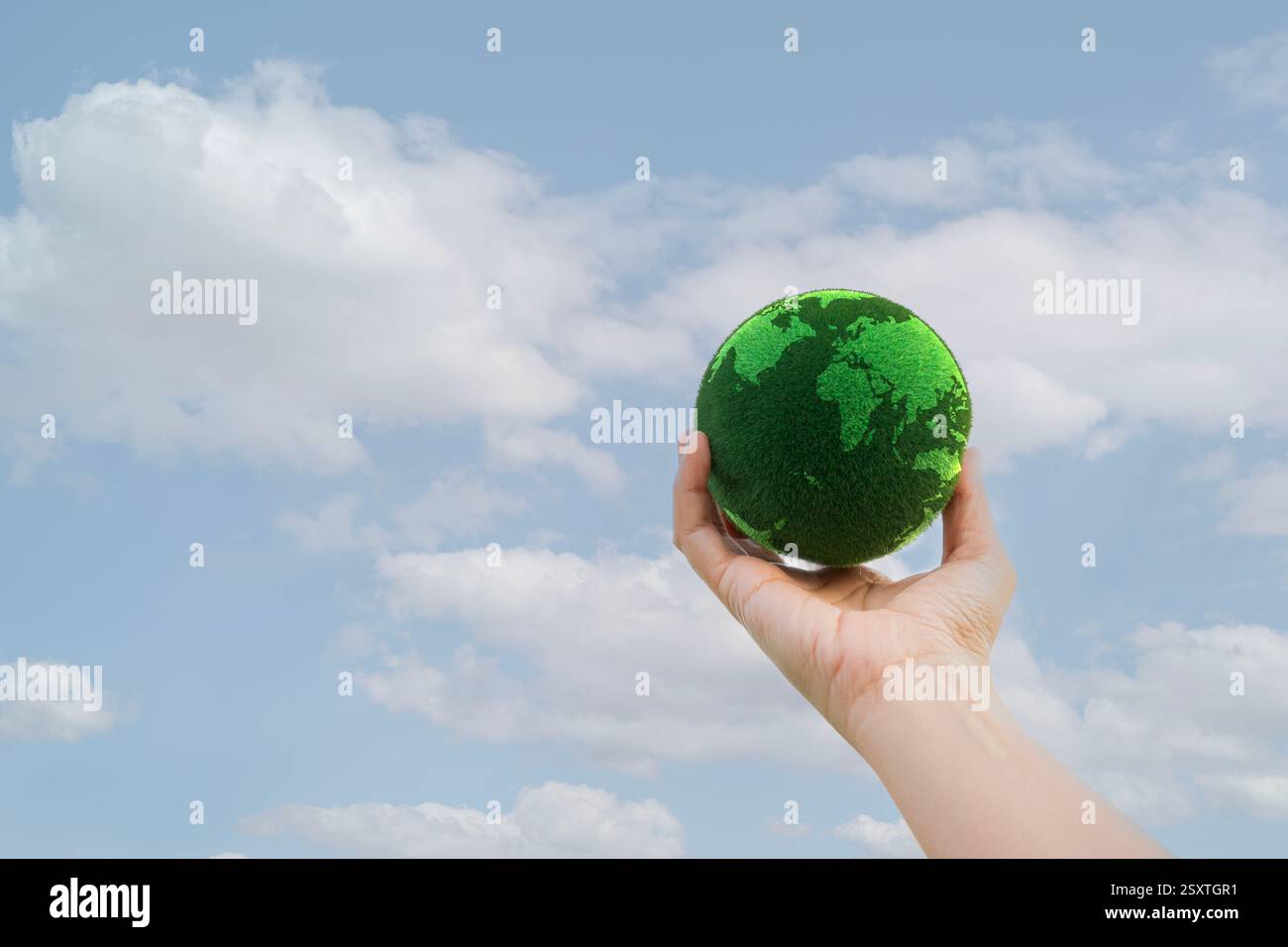 Female hands holding planet earth in rural scene. A close-up view of a ...