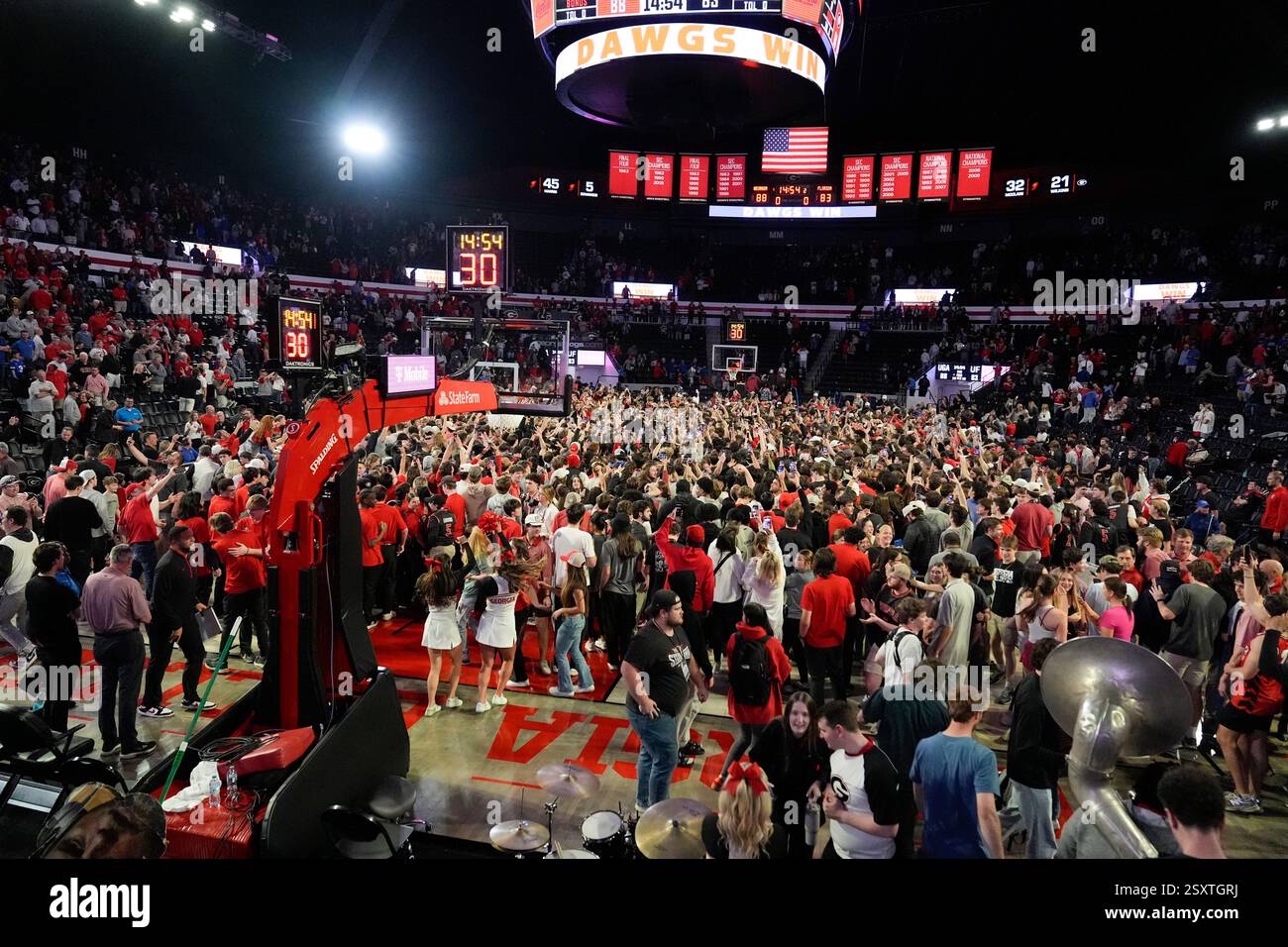 Georgia fans rush the court in celebration after an NCAA college ...