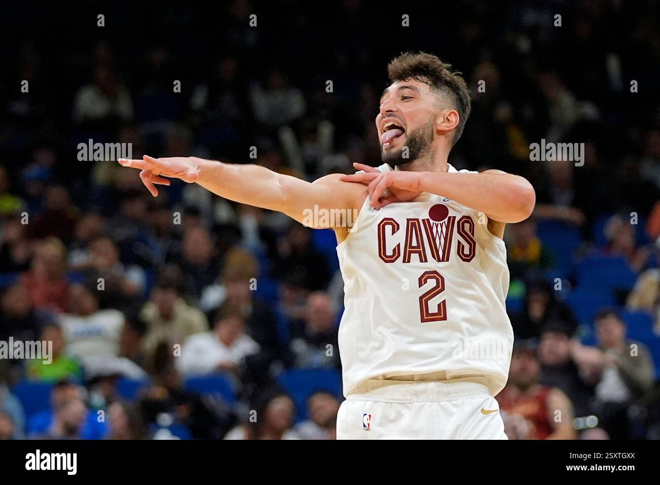 Cleveland Cavaliers guard Ty Jerome (2) points to the team bench after ...