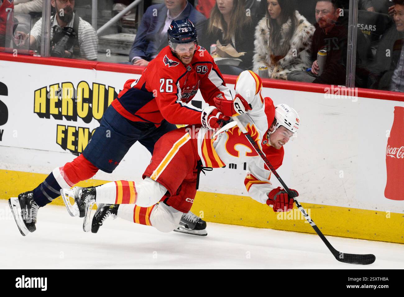 Washington Capitals center Nic Dowd (26) shoves Calgary Flames center ...