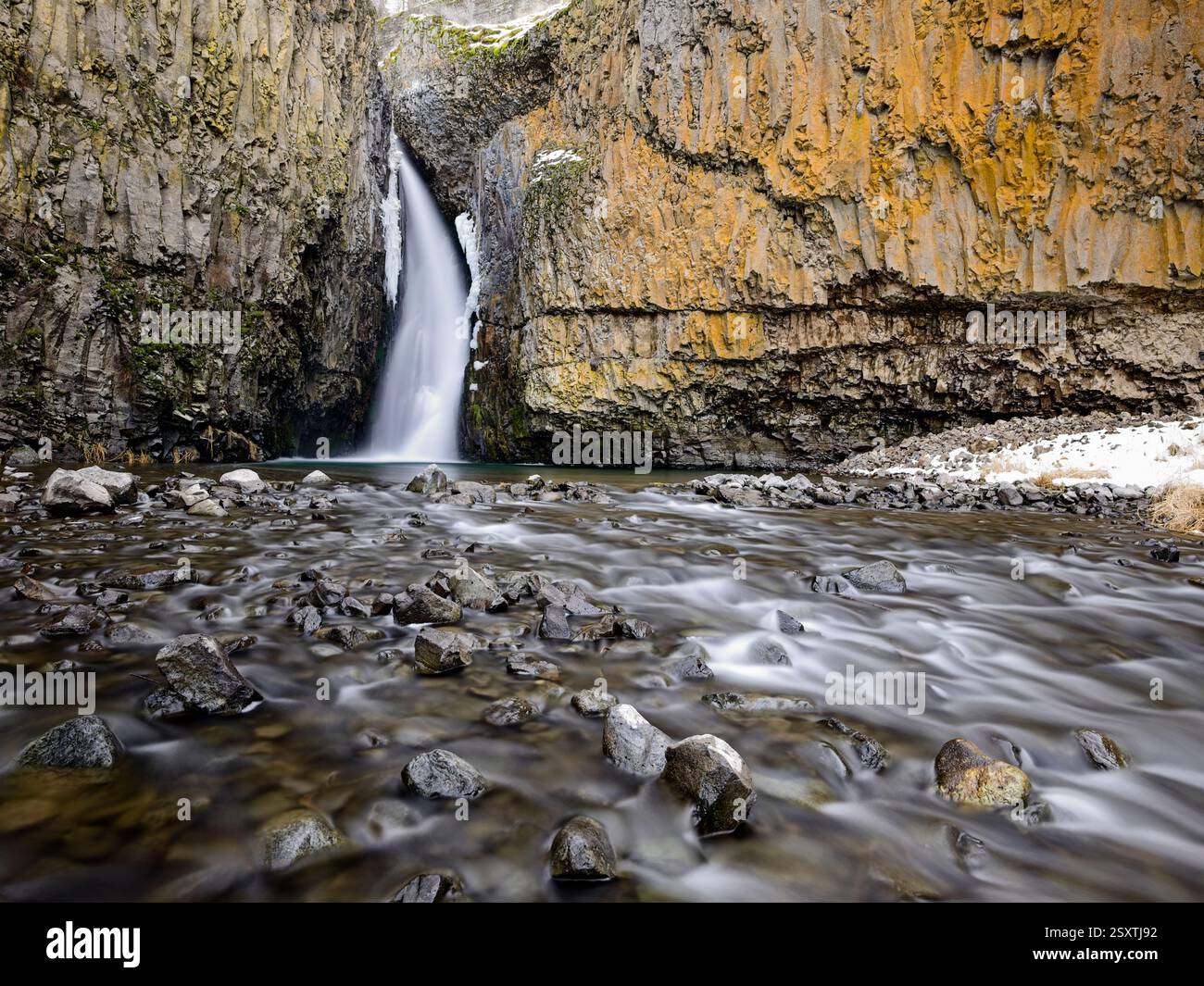 The swift flowing water of Hawk Creek Falls during winter near the ...