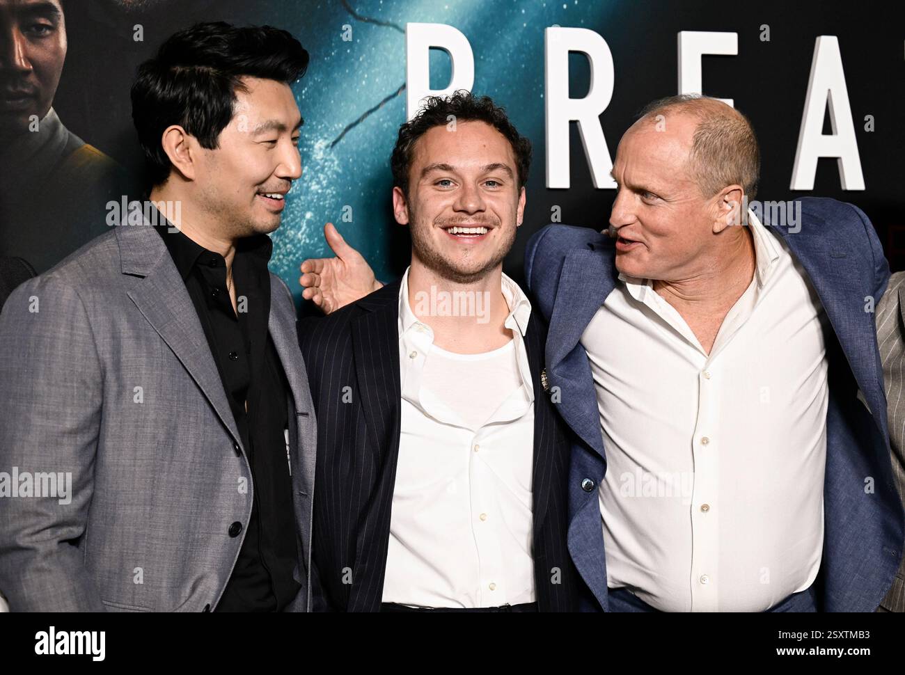 Simu Liu, left, Finn Cole and Woody Harrelson attend the premiere of ...
