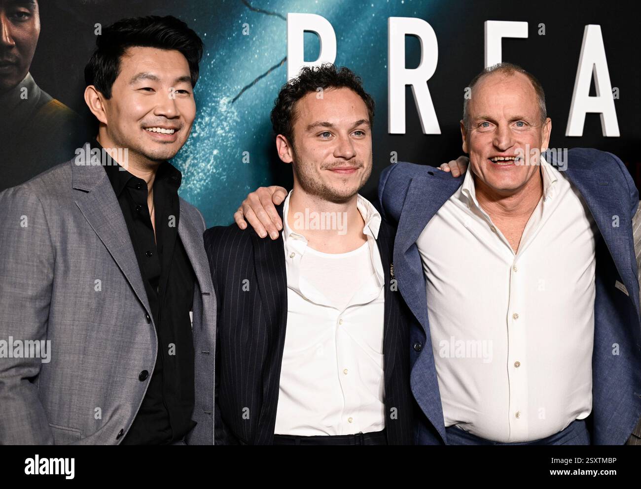 Simu Liu, left, Finn Cole and Woody Harrelson attend the premiere of ...