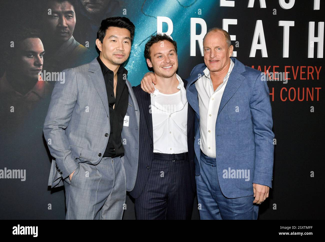 Simu Liu, left, Finn Cole and Woody Harrelson attend the premiere of ...