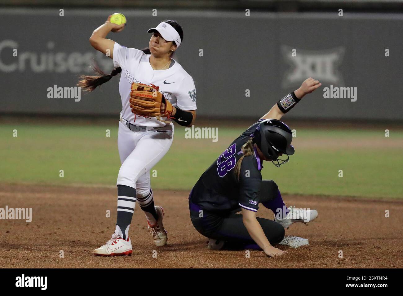 Houston second baseman Bethany Aguilar, left, attempts to turn a double ...