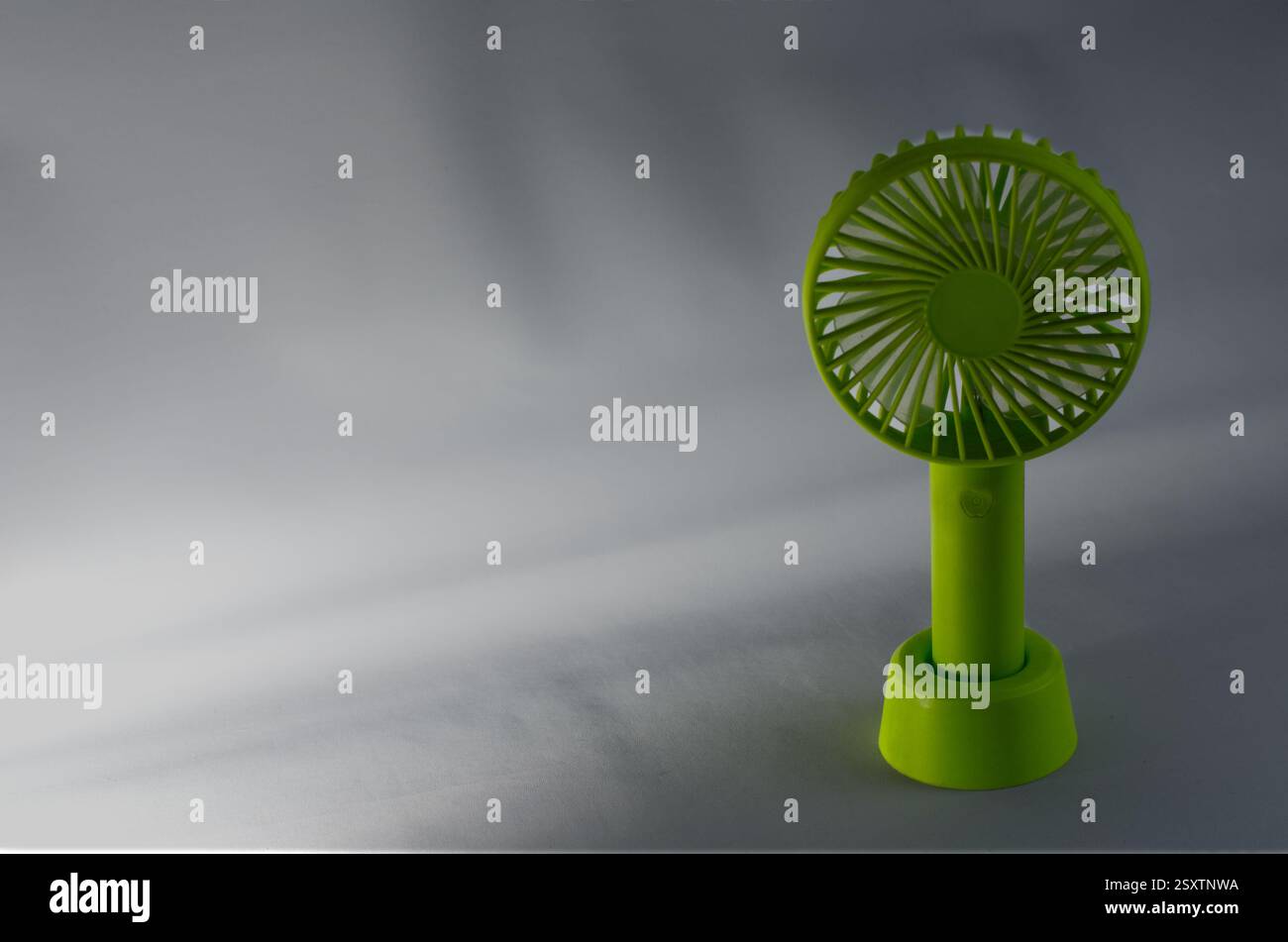 Green Handheld Fan Against Neutral Background in Studio Lighting Stock ...