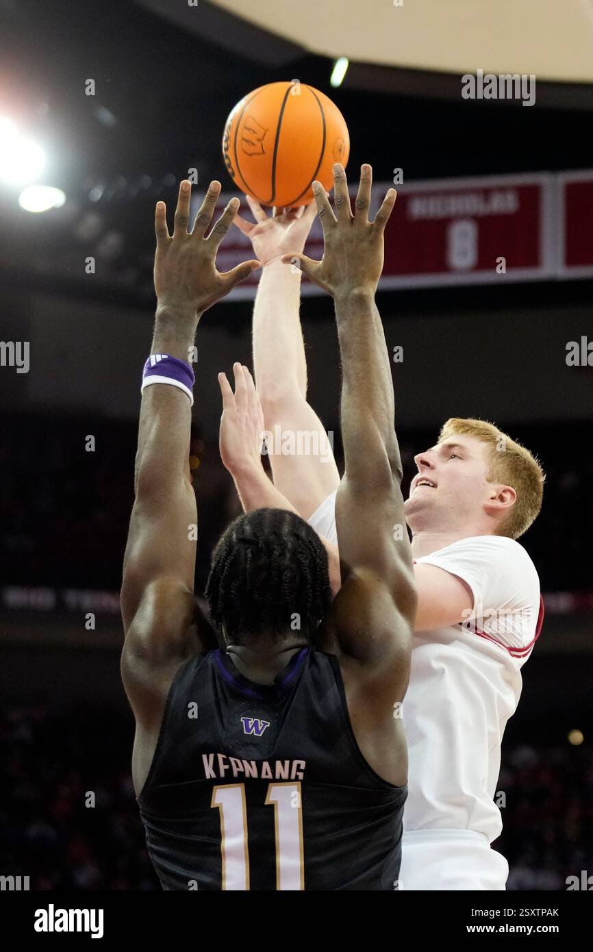 Wisconsin forward Steven Crowl, right, scores against Washington center ...