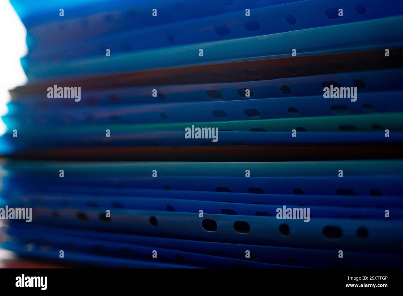 A vibrant collection of plastic folders in various shades of blue is ...