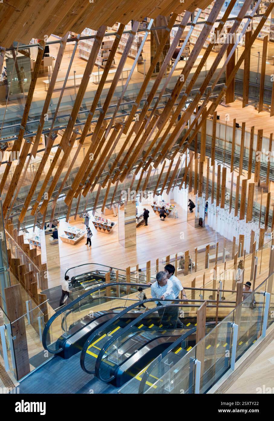 Visitors walk through the Kengo Kuma-designed building that houses the ...