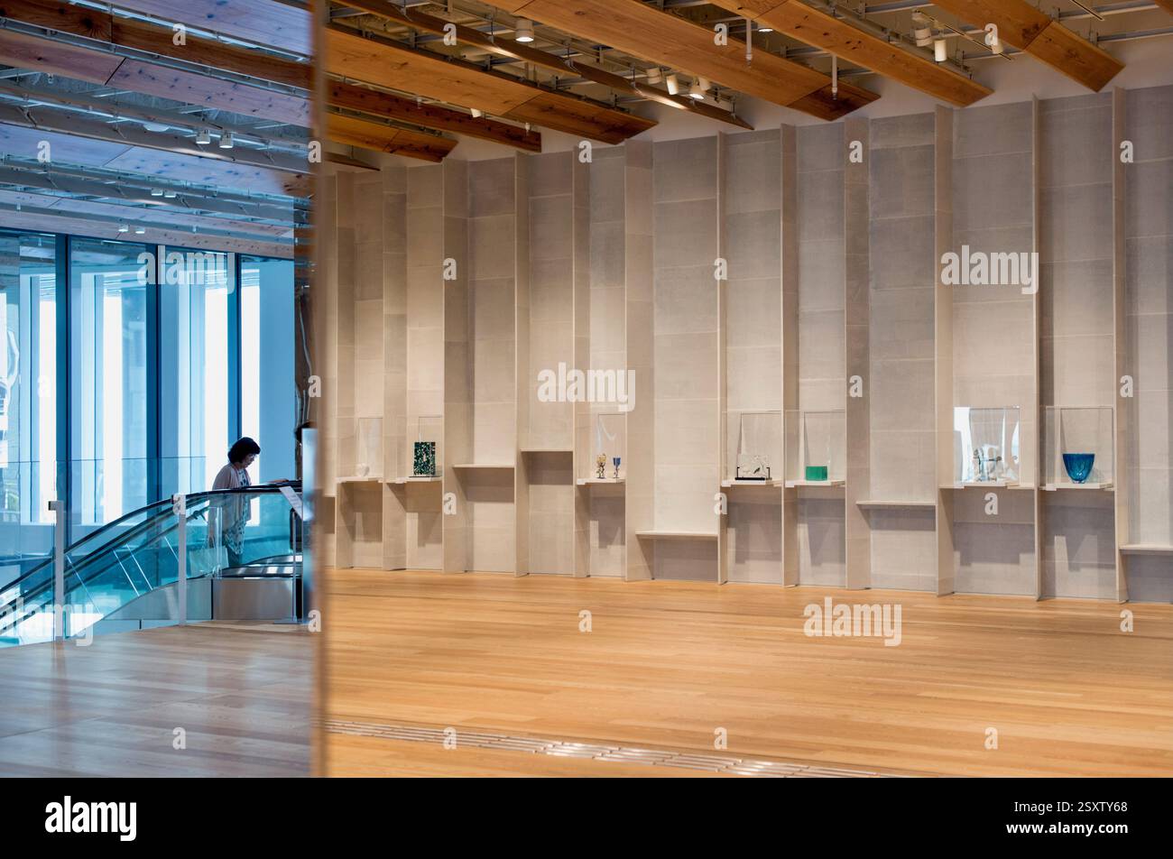 Visitors admire some of the glass art works on display inside the ...