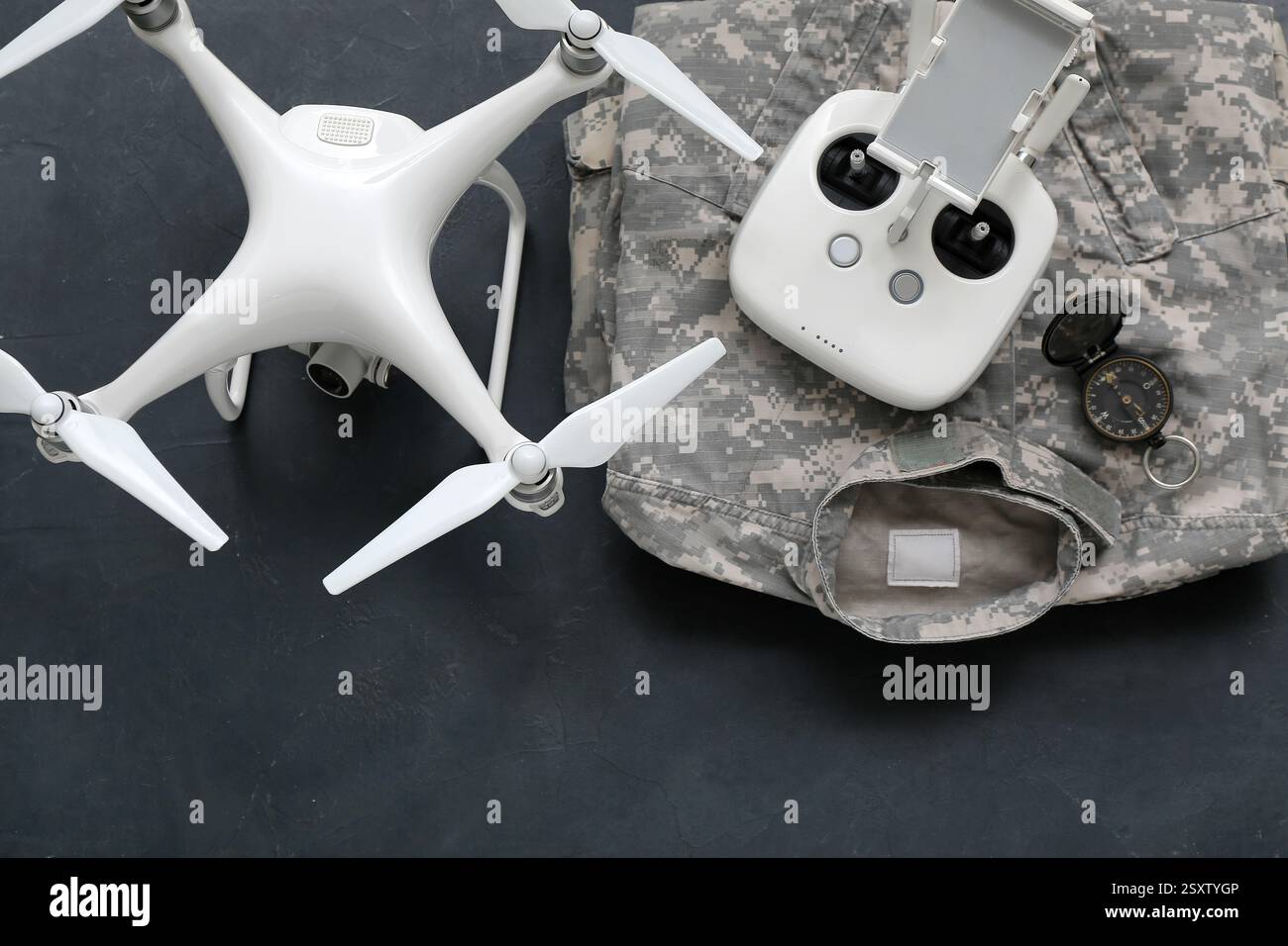 Modern quadcopter, military uniform and compass on black background ...
