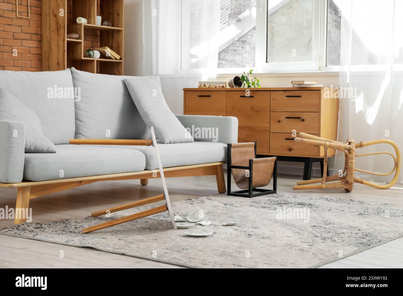 Interior of damaged living room with sofa and overturned table after ...