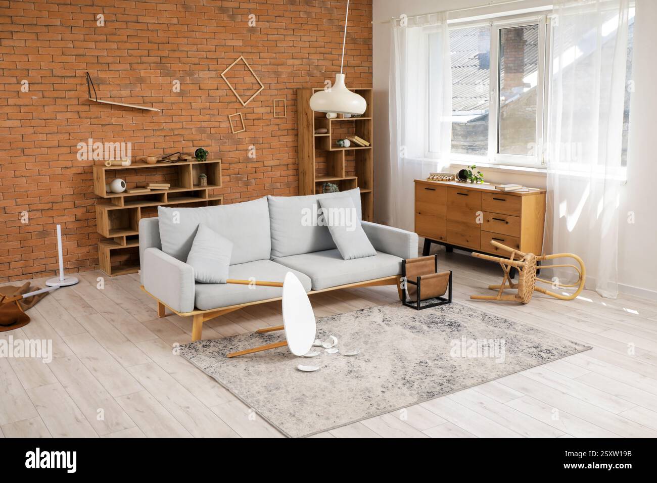 Interior of damaged living room with sofa and overturned table after ...