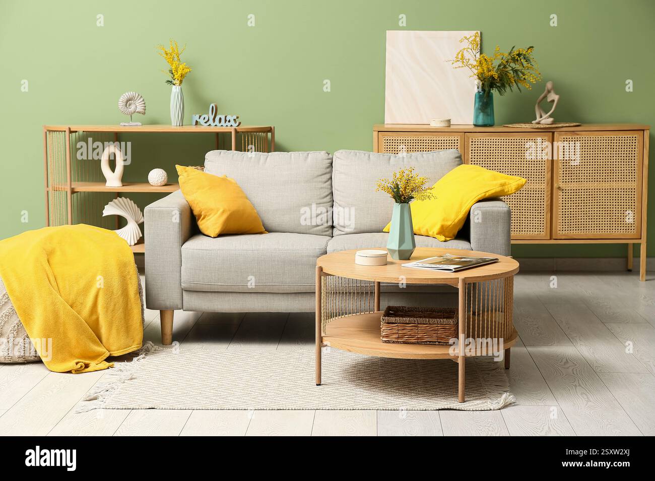 Interior of living room with sofa and mimosa flowers in vases Stock ...