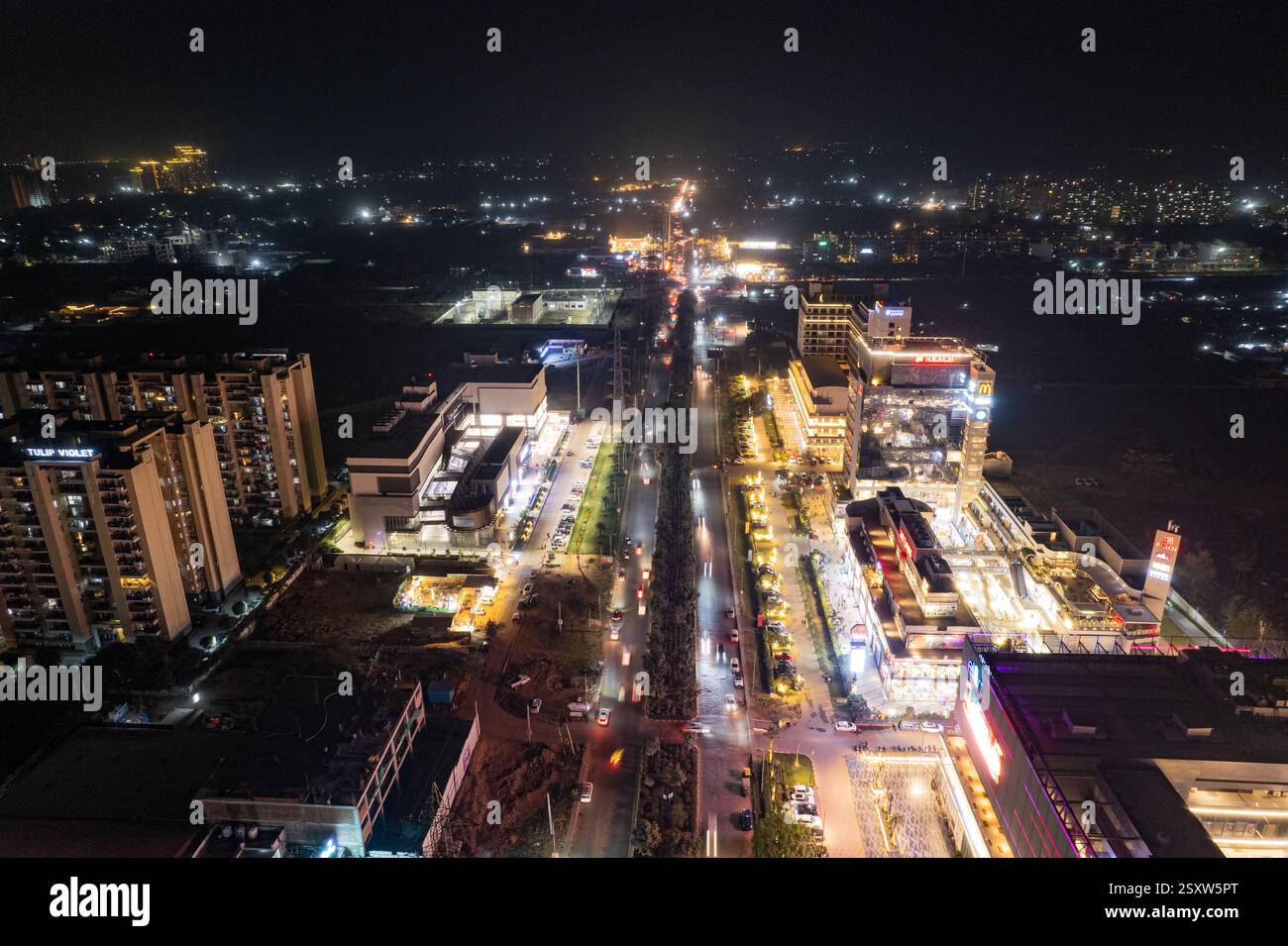 aerial drone night shot showing well lit shopping malls elan Reach 3 ...