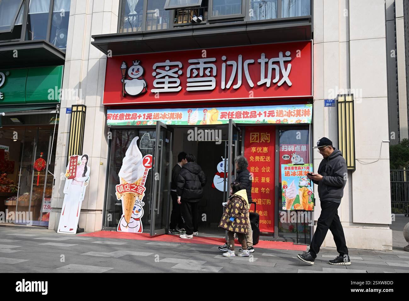 A citizen walks past a MIXUE Ice Cream & Tea shop in Nanjing, Jiangsu ...