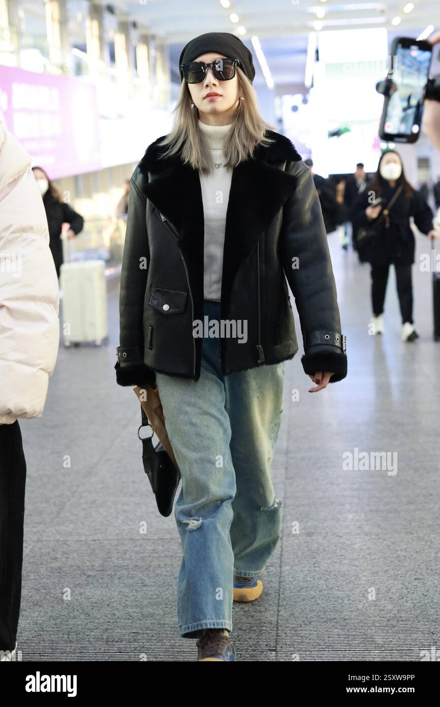 Chinese singer and actress Meng Meiqi appears at the airport in Beijing ...