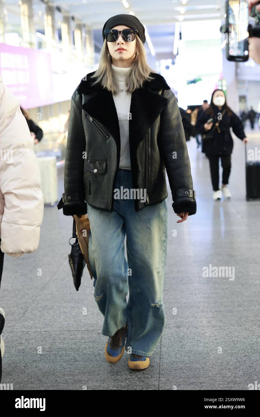 Chinese singer and actress Meng Meiqi appears at the airport in Beijing ...