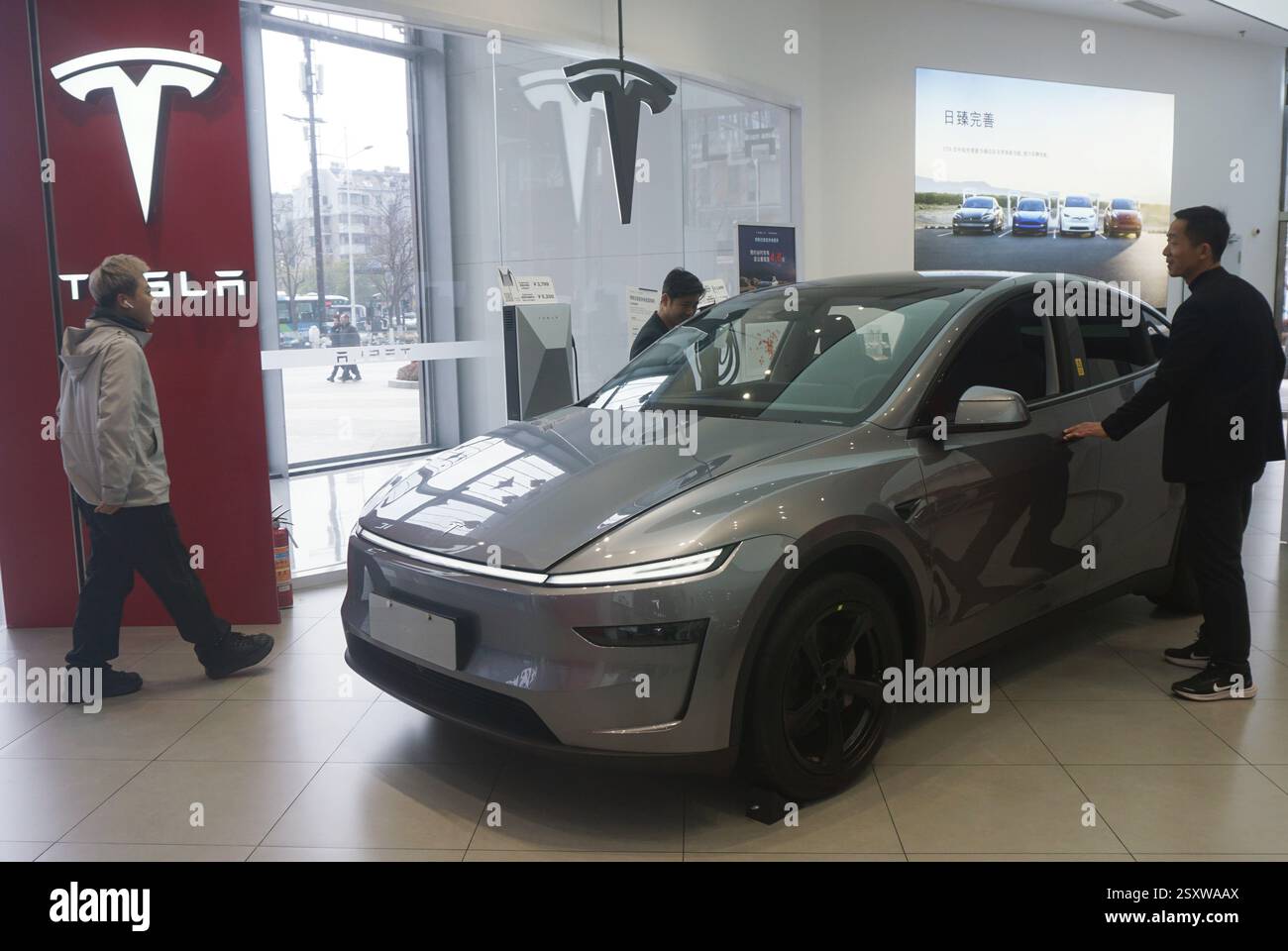 HANGZHOU, CHINA - FEBRUARY 26, 2025 - Customers look at the new Model Y ...