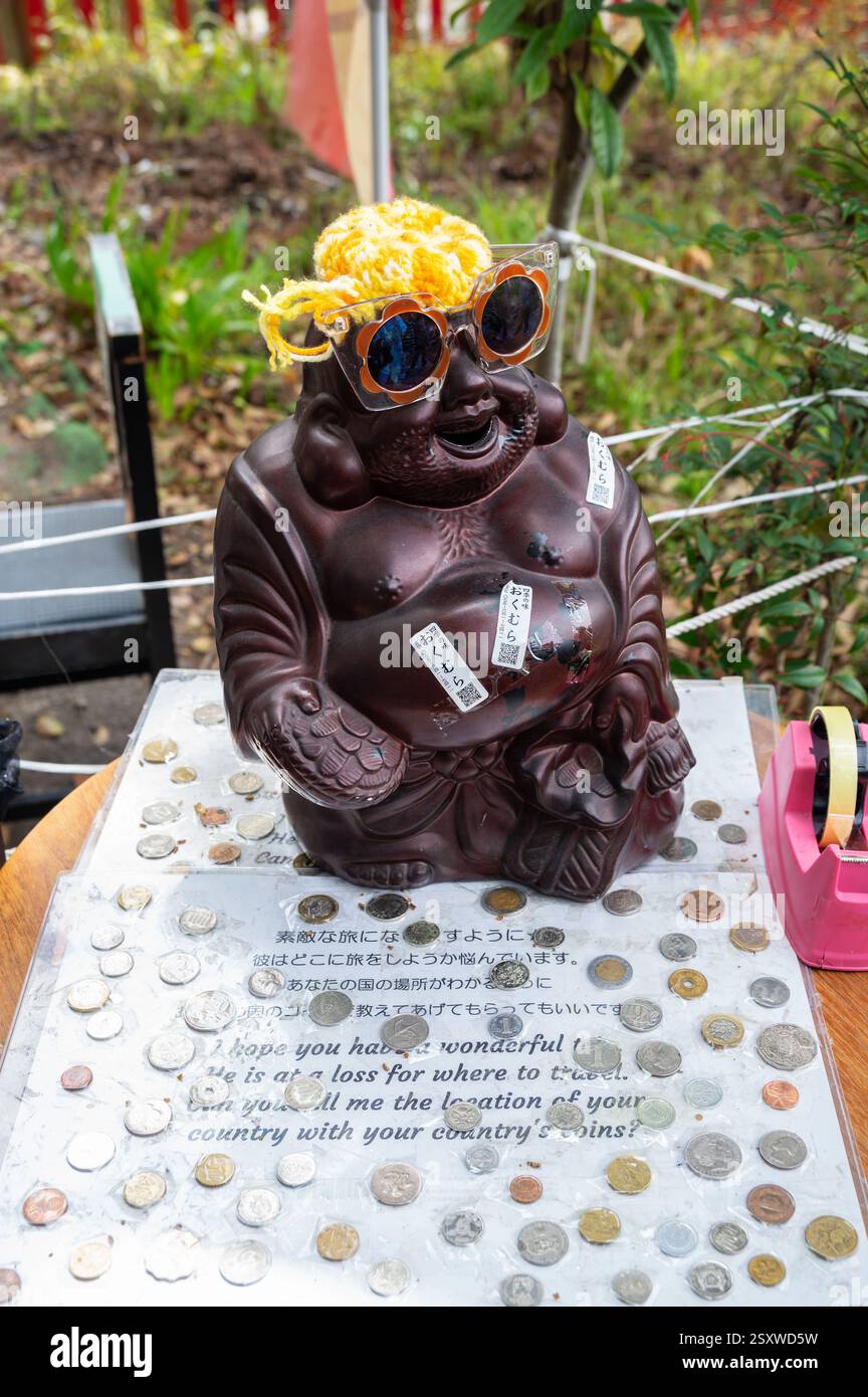 Japanese laughing Buddha on display inside the Fushimi Inari shrine ...