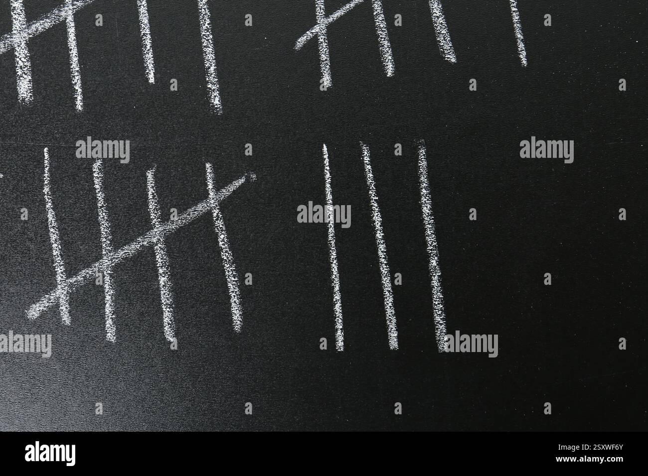 Counting days by drawing sticks with chalk on blackboard, closeup Stock ...