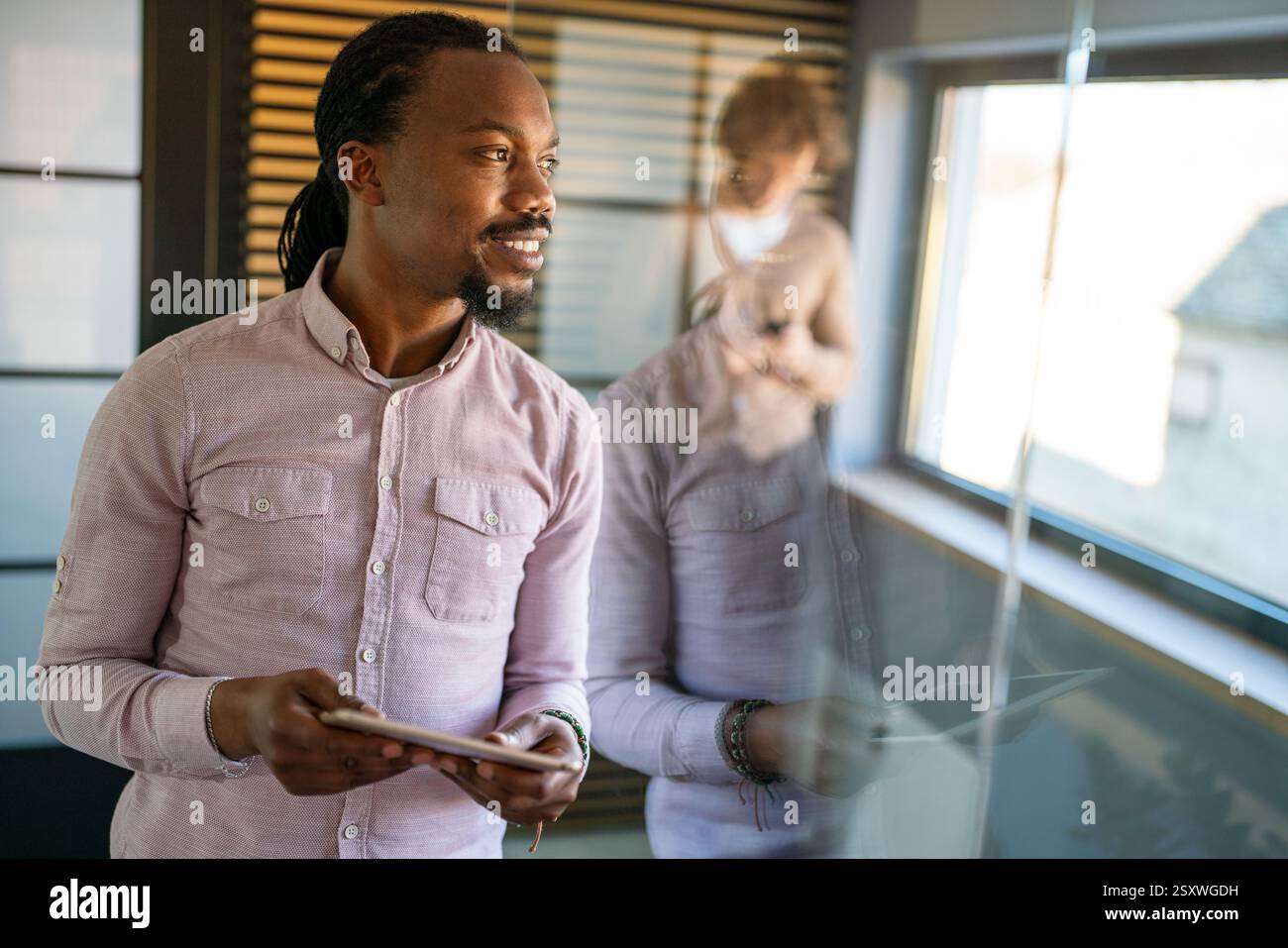 Successful African American businessman reading business graphs and ...