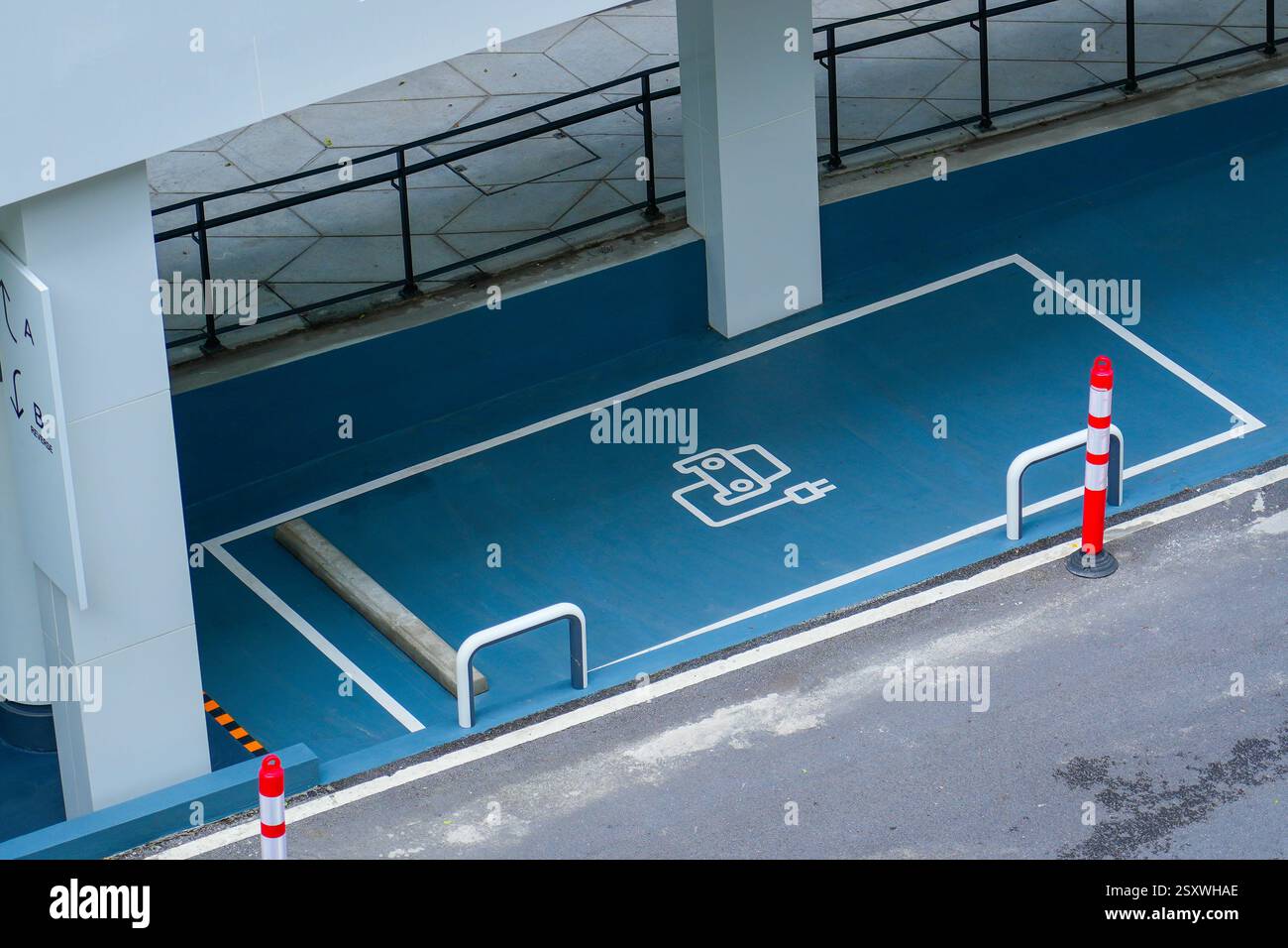 A well-designed electric vehicle charging station awaits use, situated ...